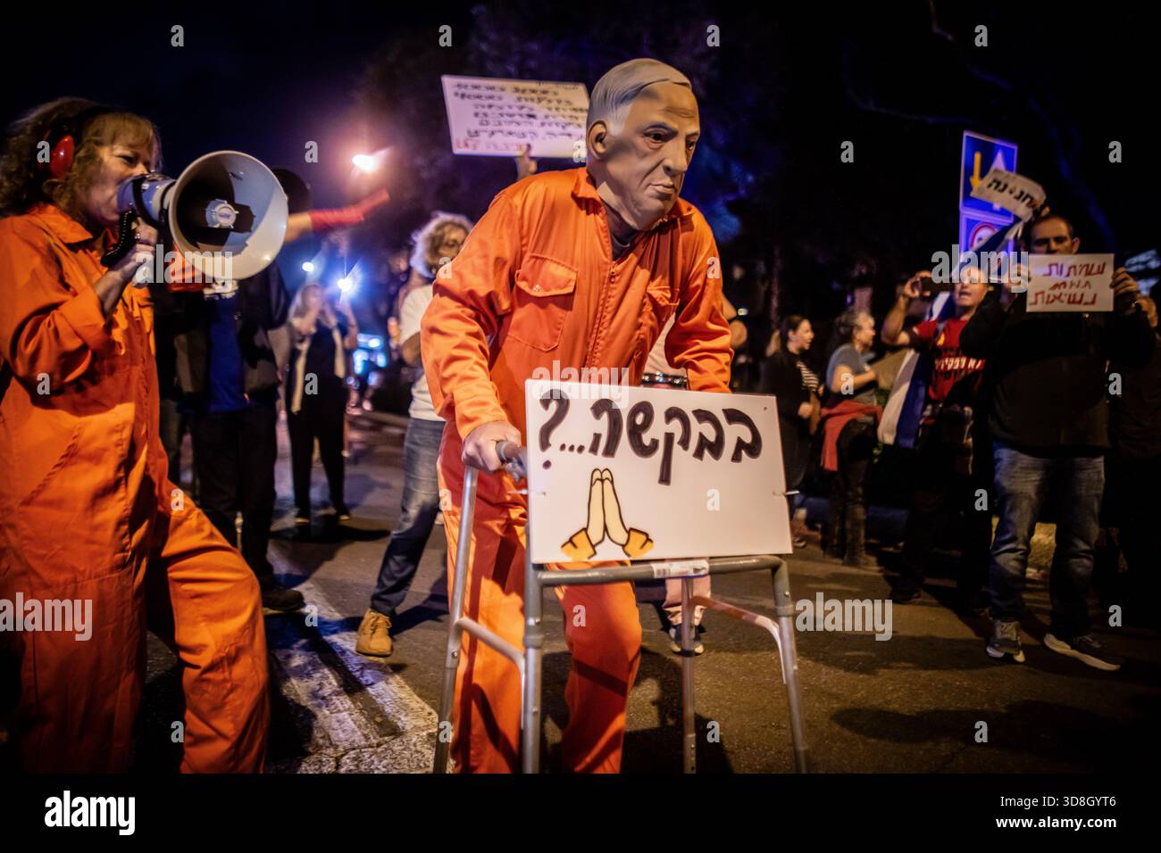 An Israeli protestor wears a mask portraying Israeli Prime Minister ...