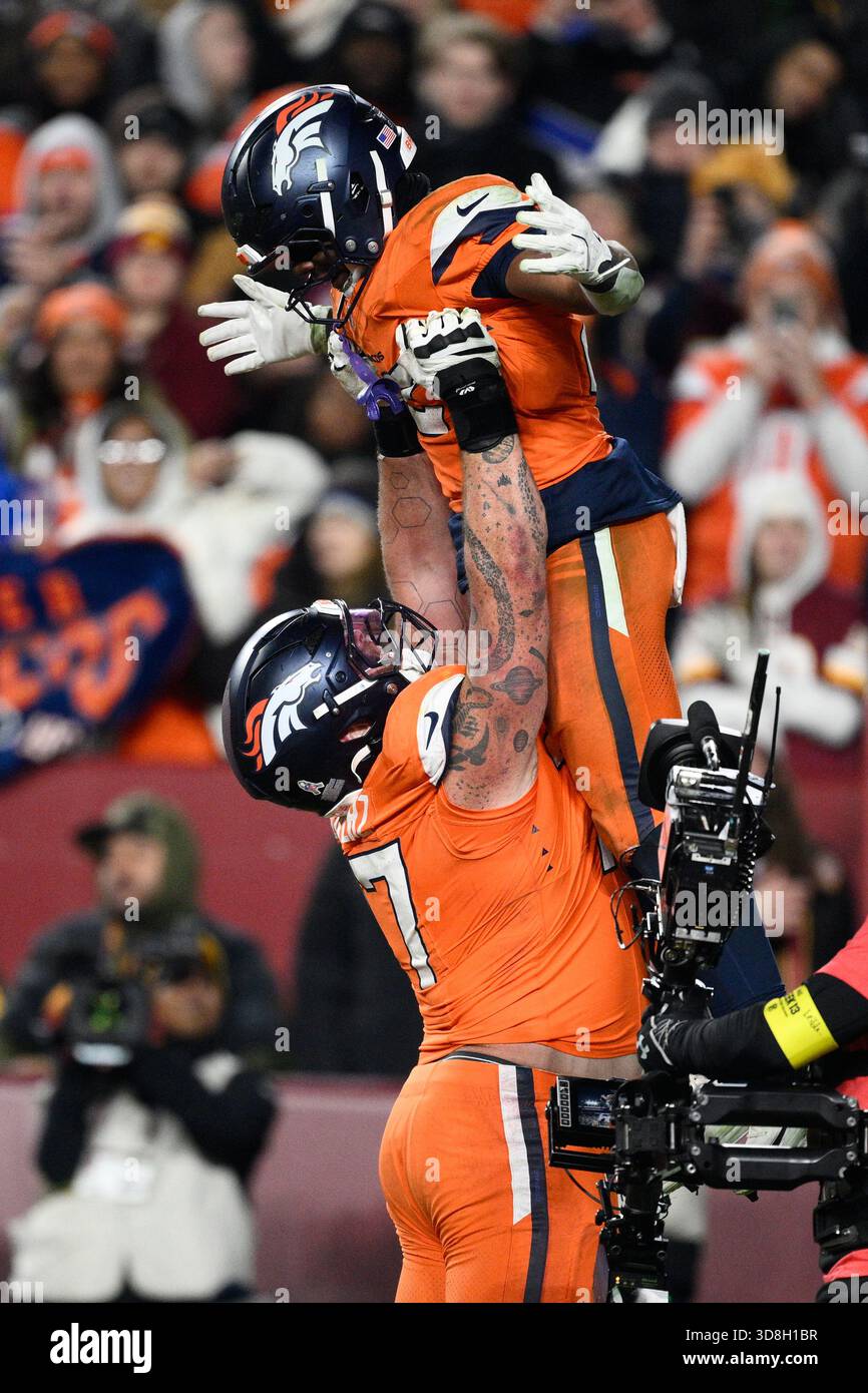 Denver Broncos running back RJ Harvey is lifted up by teammate Quinn ...