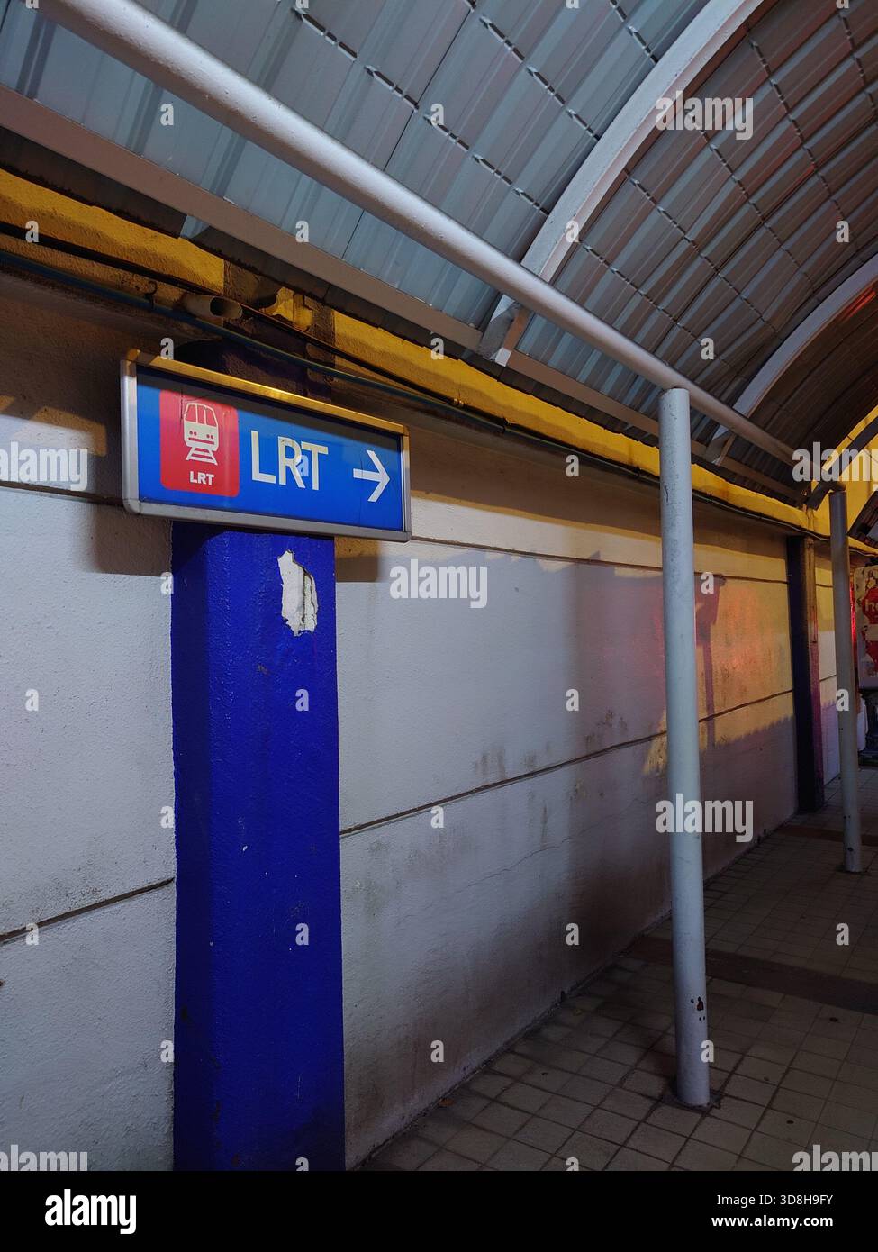 Directional signboard pointing towards the Light Rail Transit (LRT ...