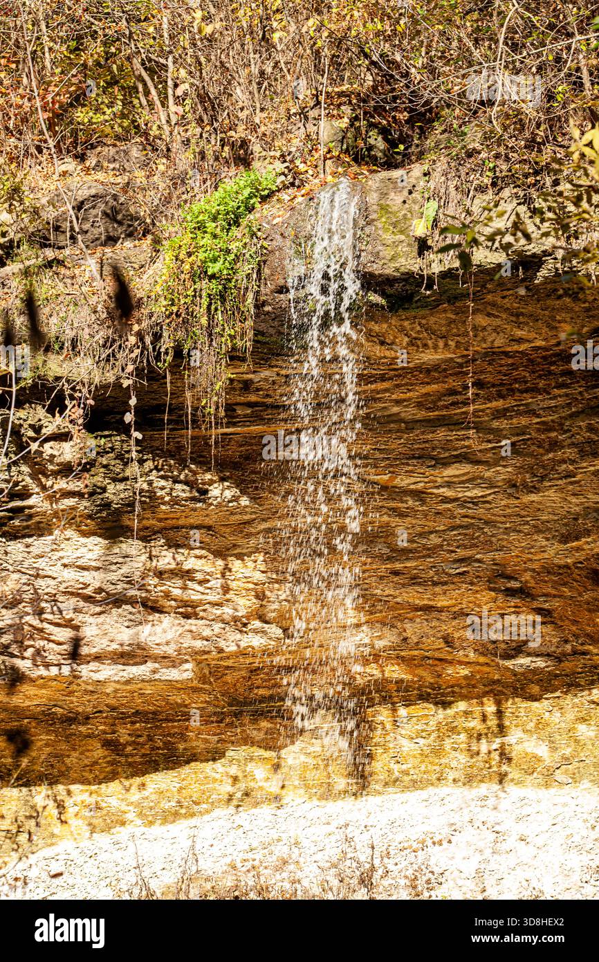 A powerful waterfall cascades through the forested cliffs of Parc des ...