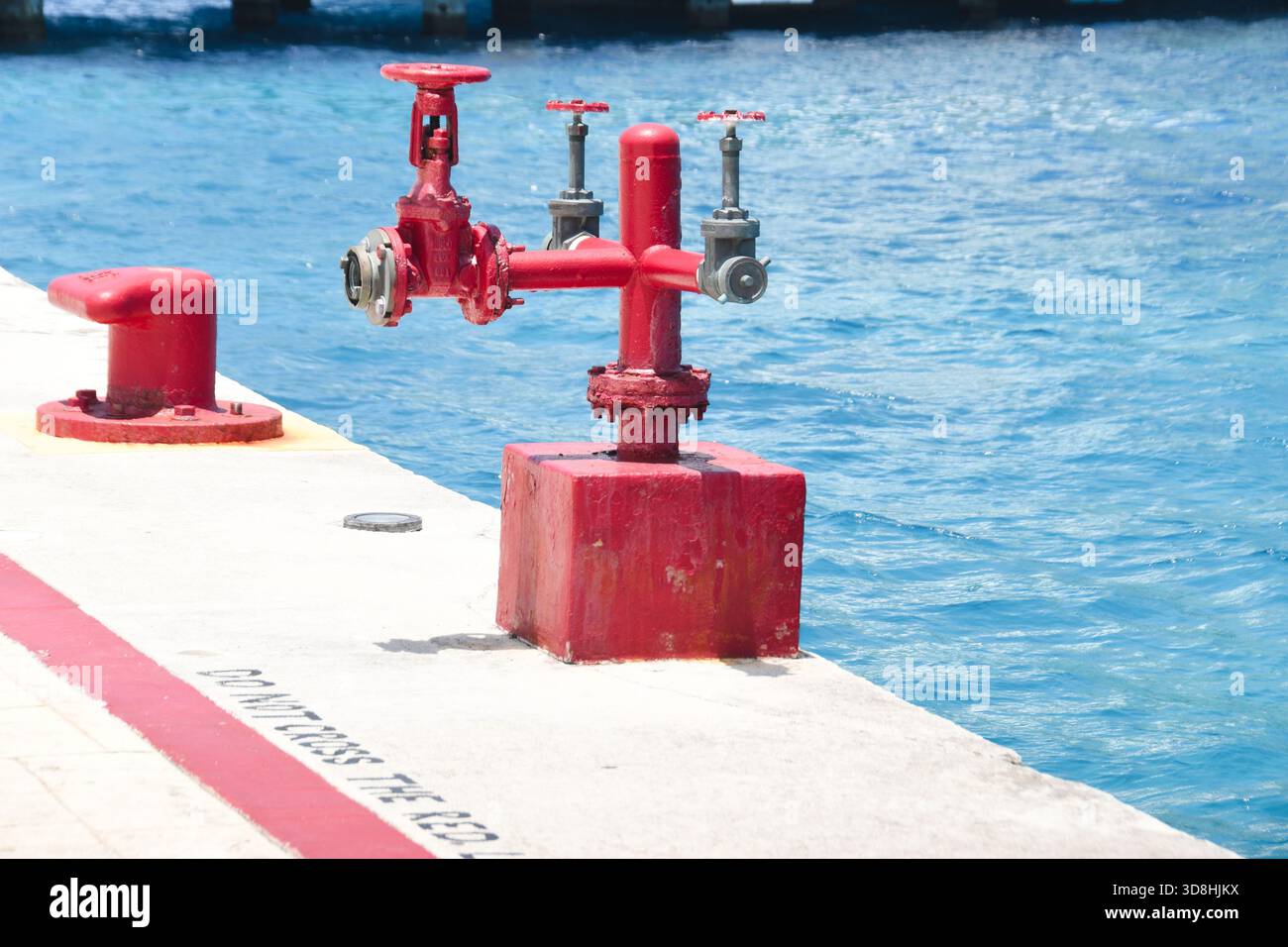 Red fire pump connection on a harbor pier Stock Photo - Alamy