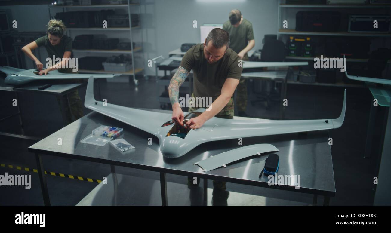 Focused Engineers Meticulously Installing Internal Components and ...