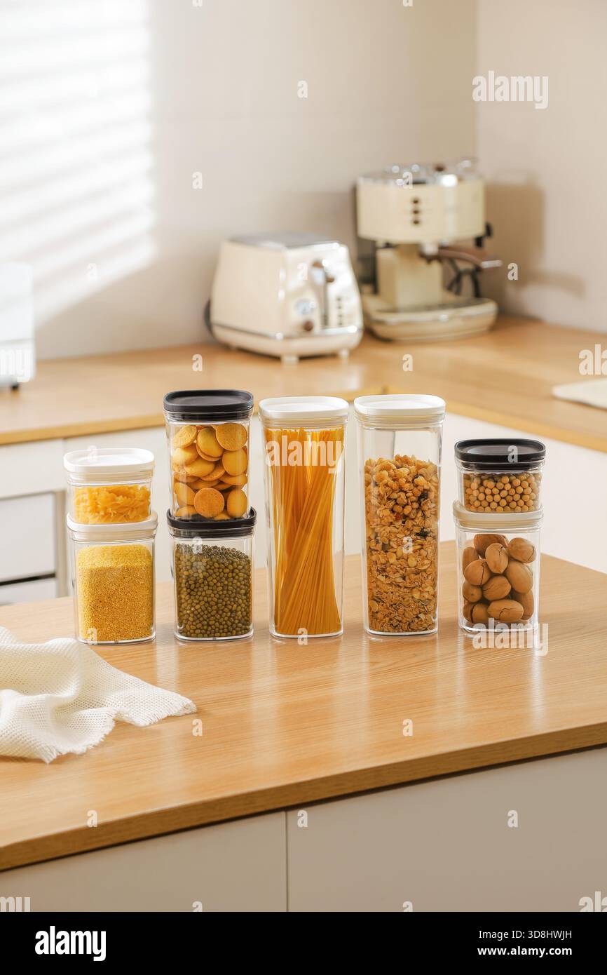 Variety of dry food ingredients in clear storage containers with white ...