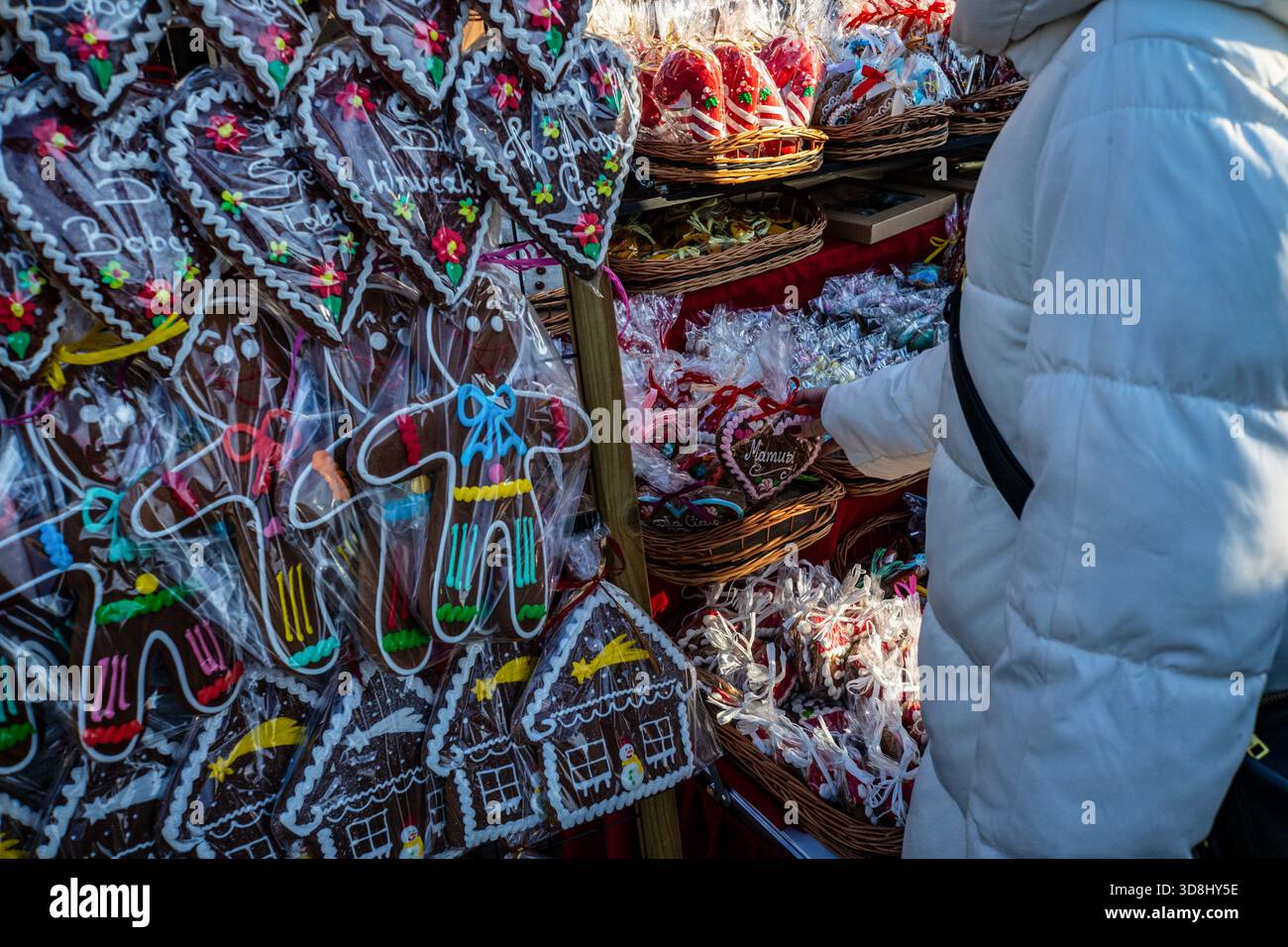 A visitor chooses a ginger Christmas cookie from one of the market ...