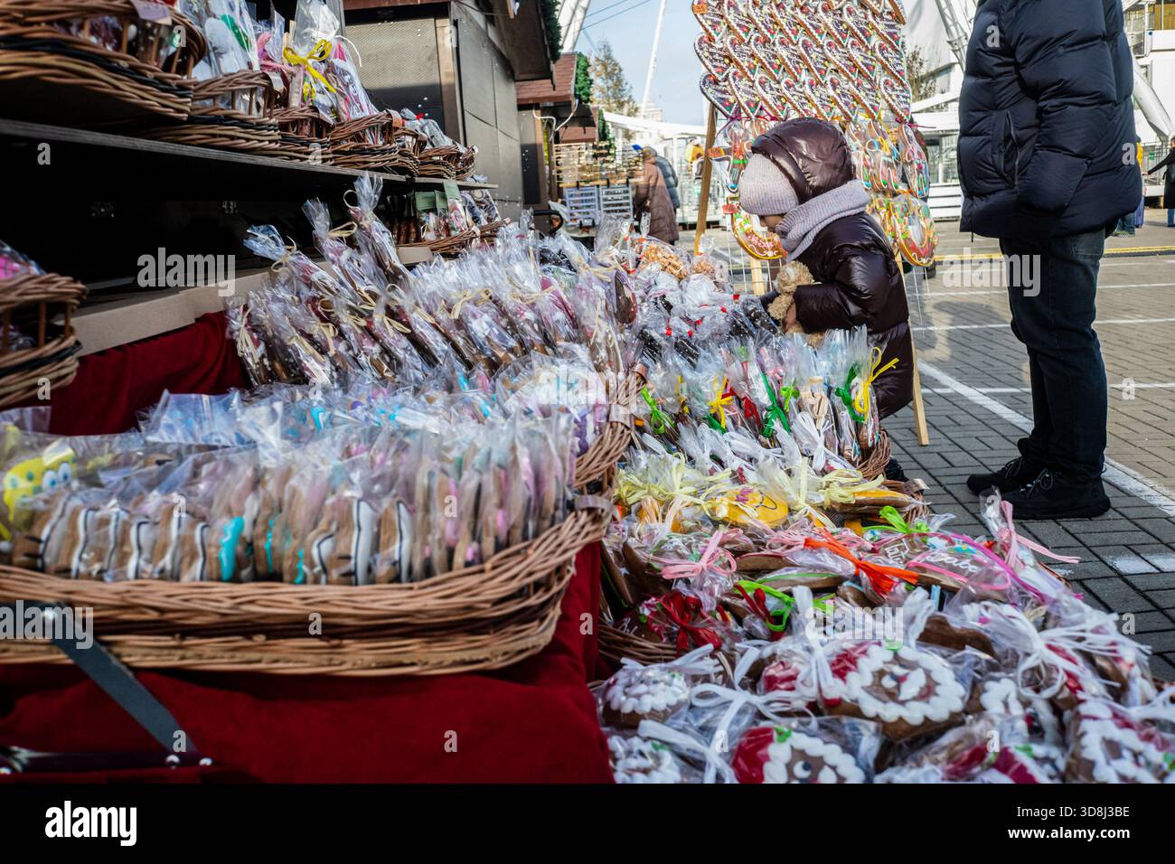 A young visitor chooses a cookie from one of the Christmas market ...