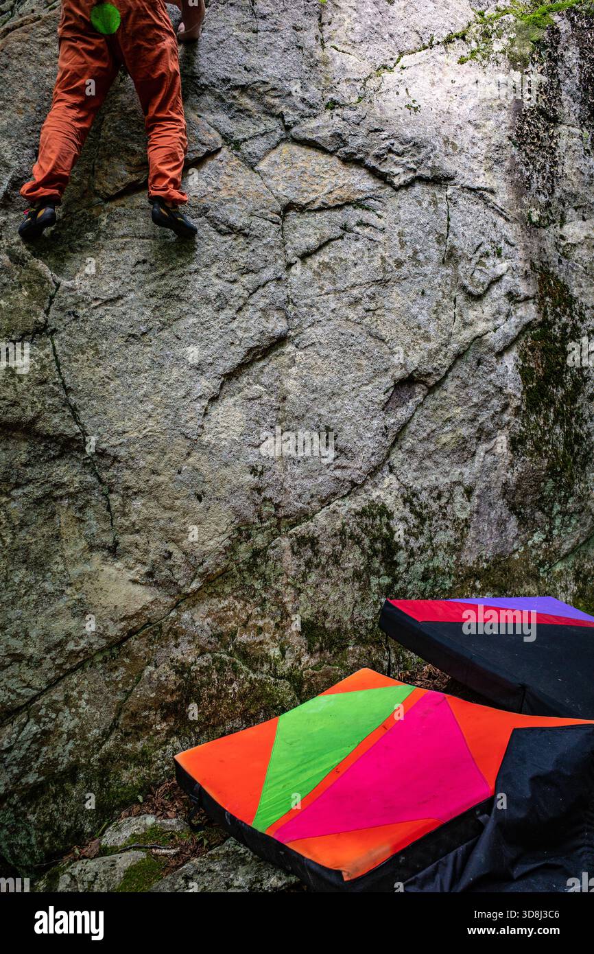The feet of a boulderer scaling a project in Franconia Notch, NH Stock ...