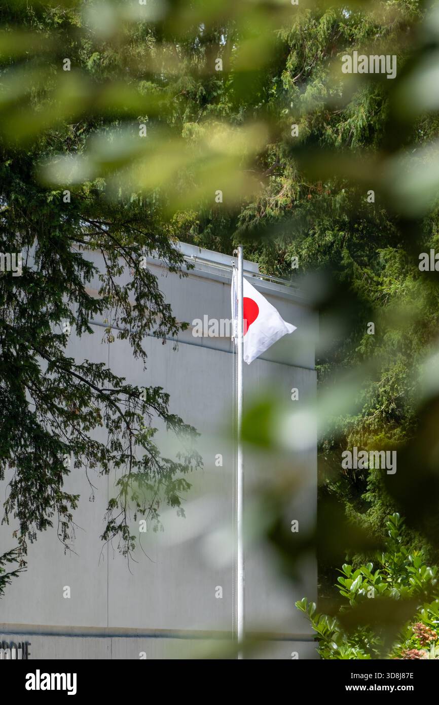 Japanese flag flying at the Japan Pavilion at Giardini della Biennale, seen through surrounding ...