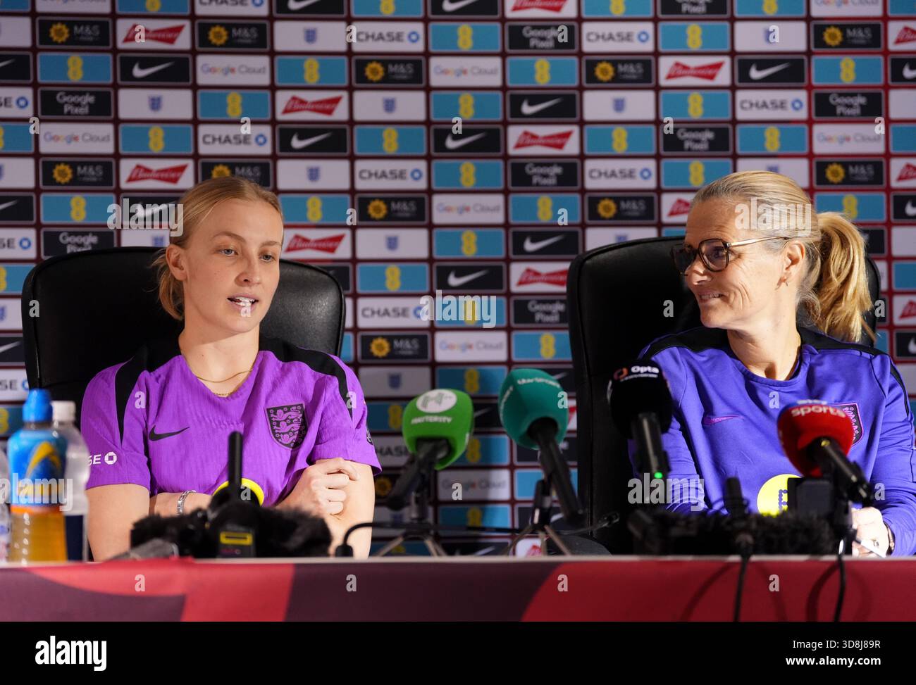 England manager Sarina Wiegman and Aggie Beaver-Jones (left) during a ...