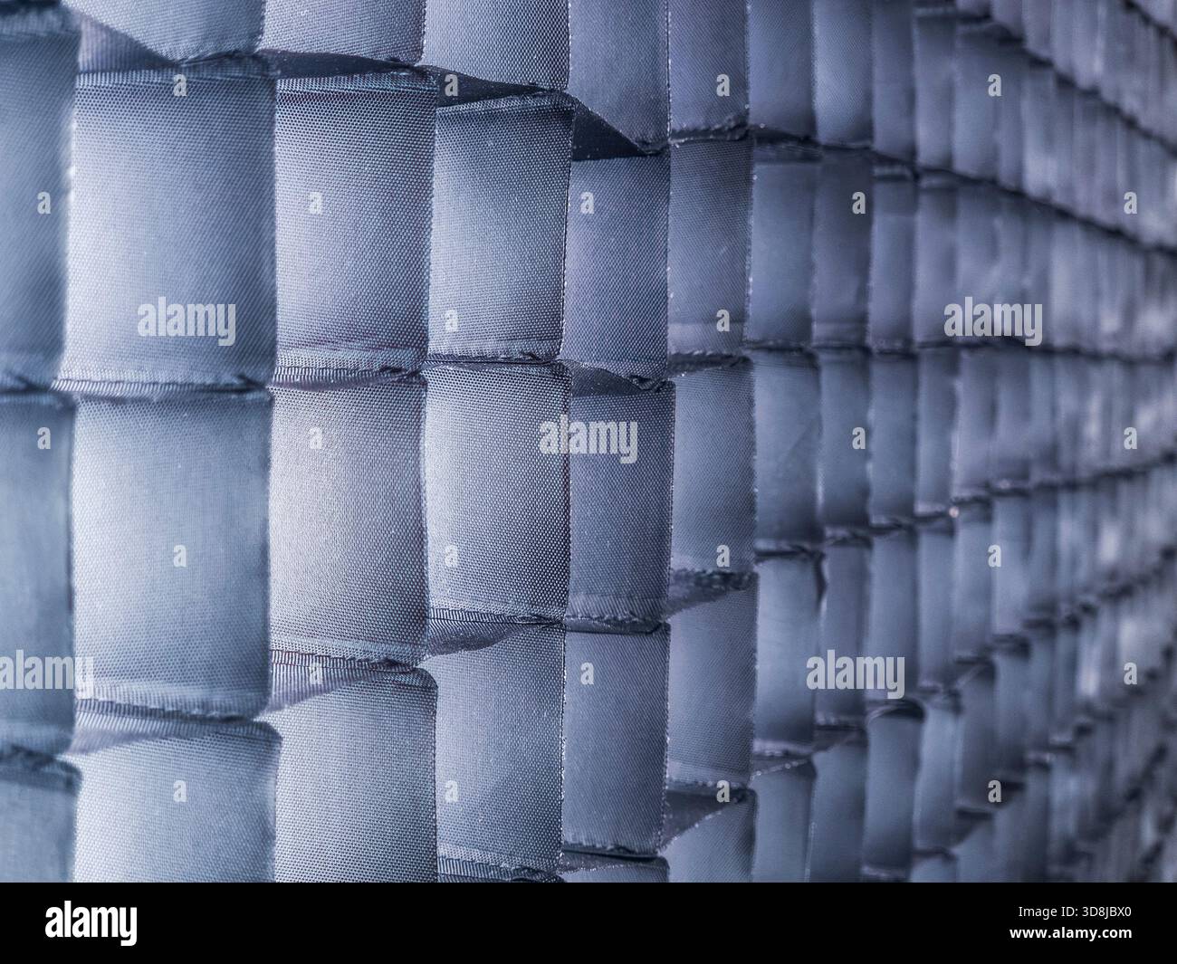 Blue honeycomb fabric forming a seamless geometric grid of illuminated ...