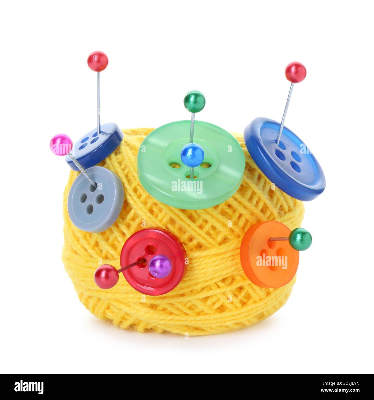 Ball of bright knitting yarn with button and pins on white background ...
