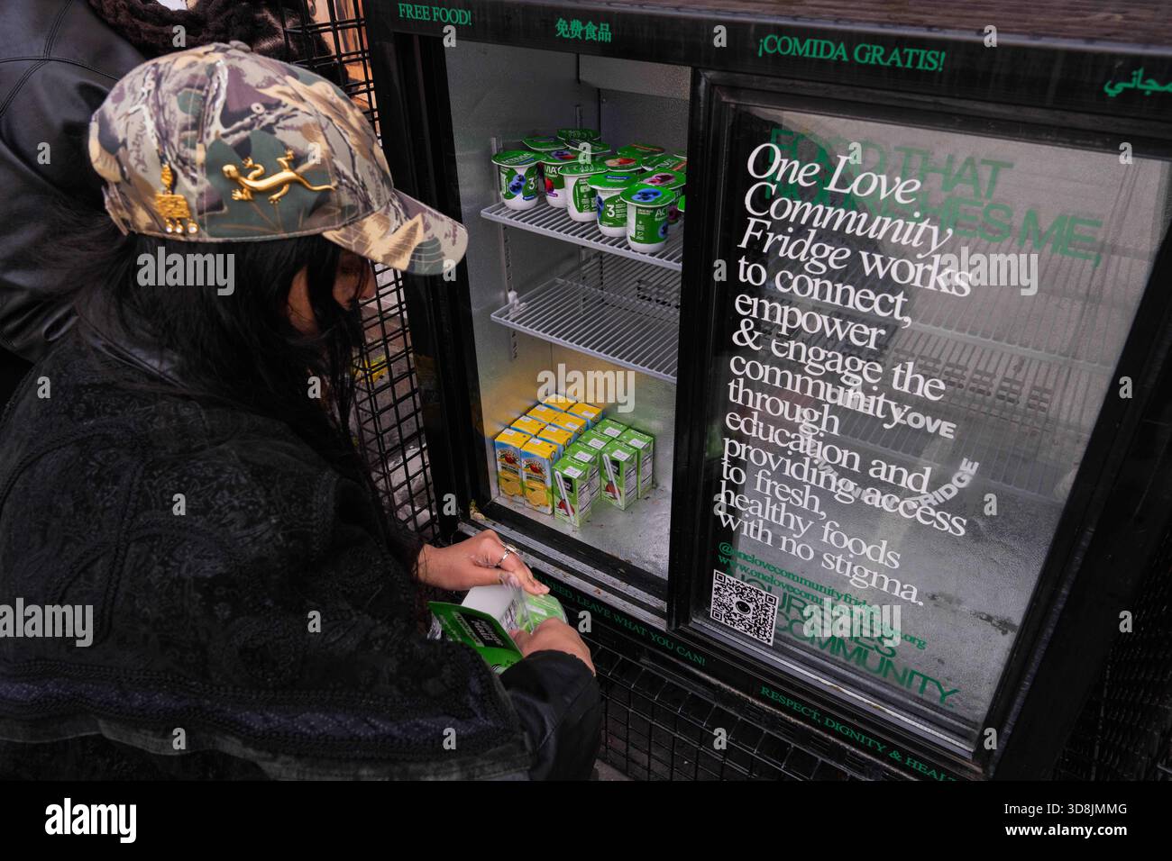 Kashish Ali and Elliott McKnight stock a One Love Community Fridge with ...