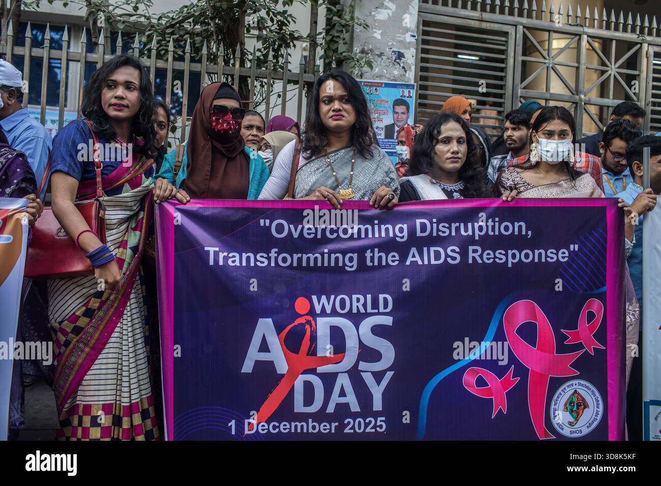 Participants and workers from various organizations hold a banner and ...
