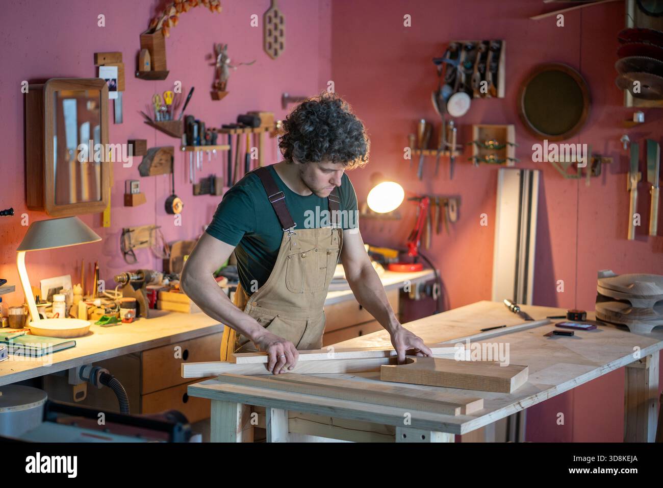 Man skilled carpenter creating unique furniture items for new work ...