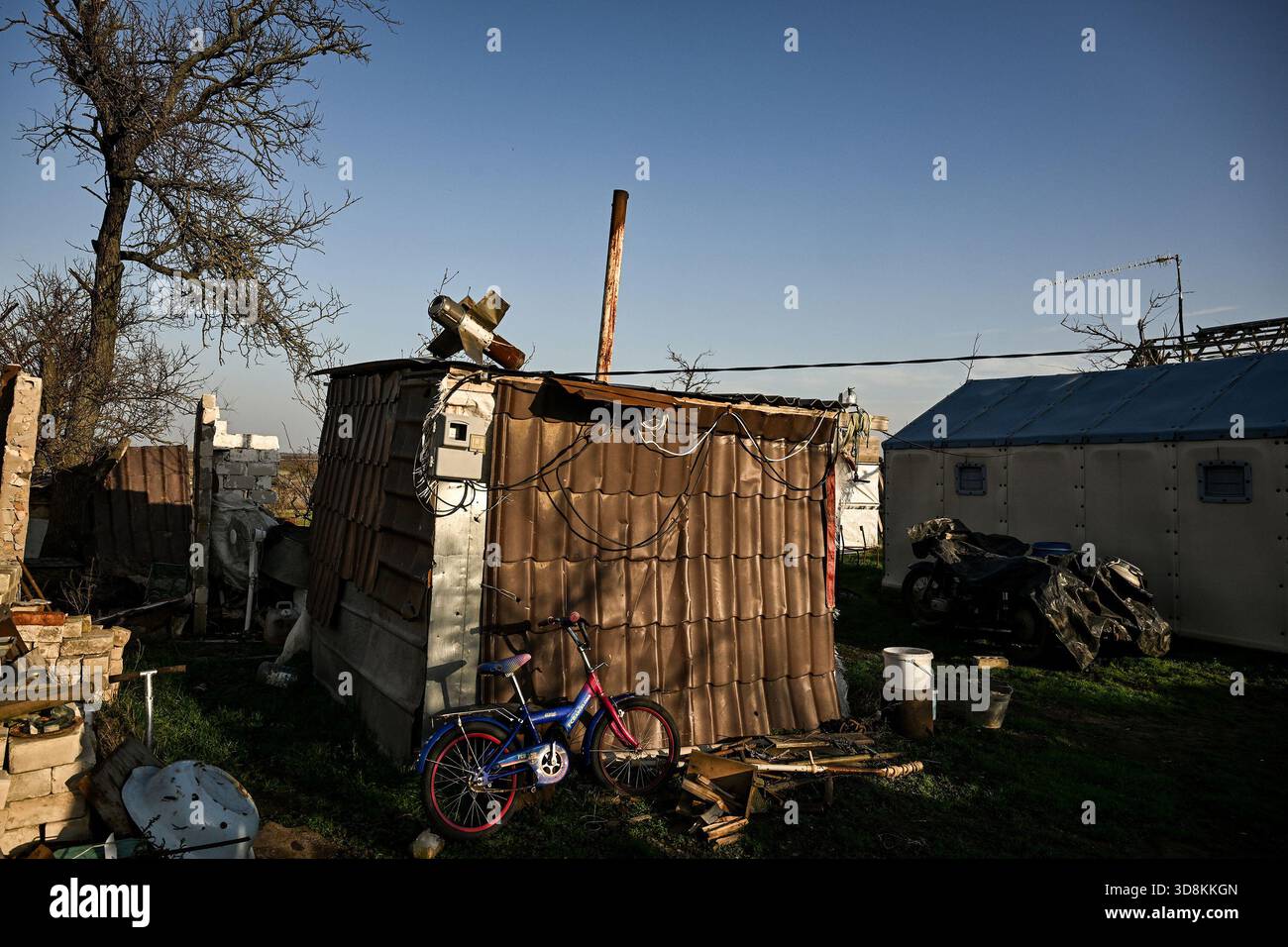 Non Exclusive: A tail stabilizer lies on the roof of a makeshift ...