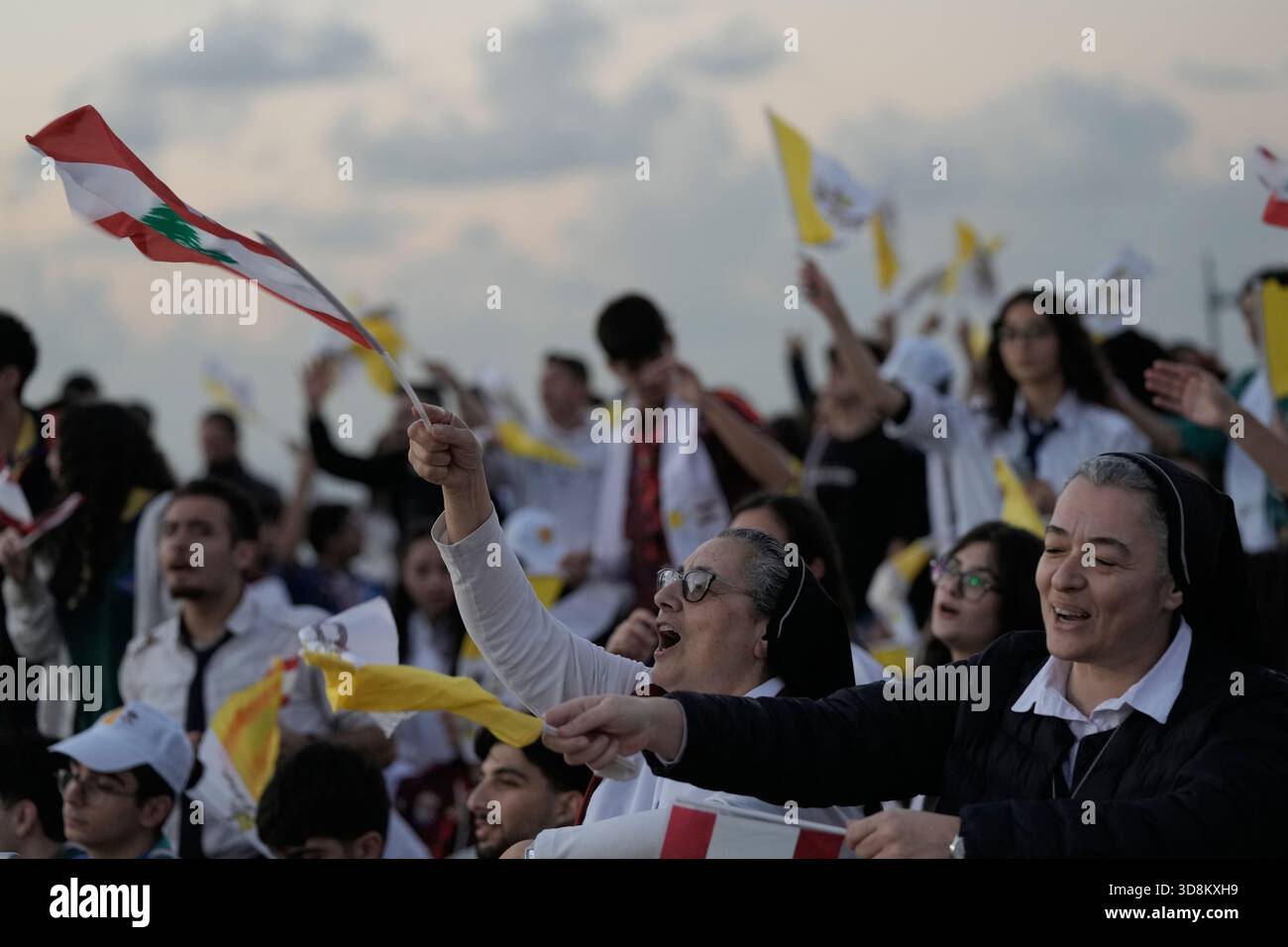 Nuns carry the Lebanese and Vatican flags ahead of a visit by Pope Leo ...
