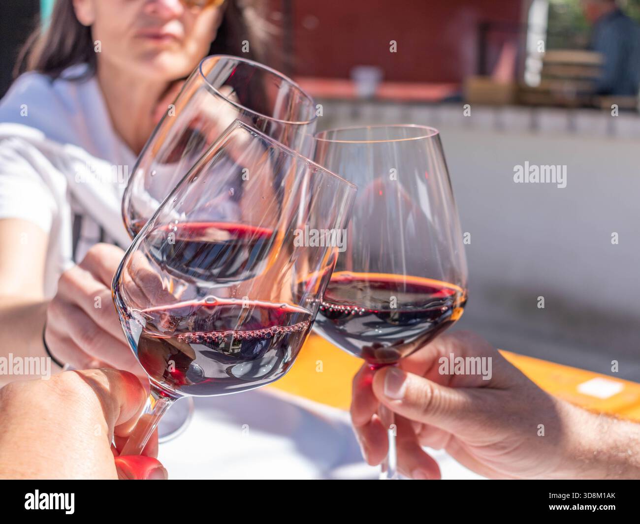 A vibrant, close-up, and candid shot capturing three wine glasses ...