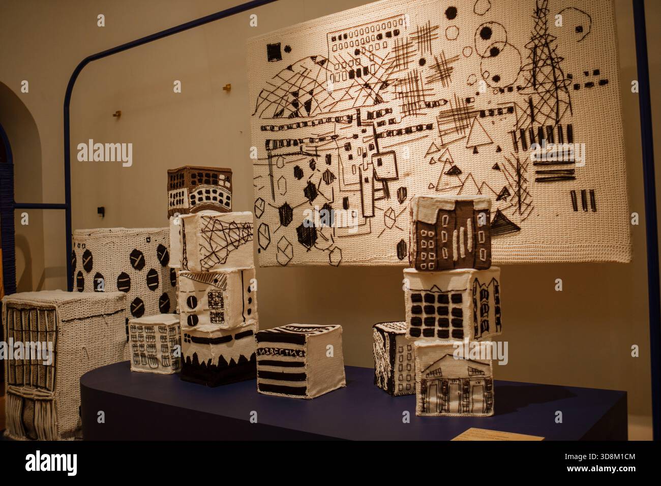 Textile art installation in a gallery includes various sculptures and a ...