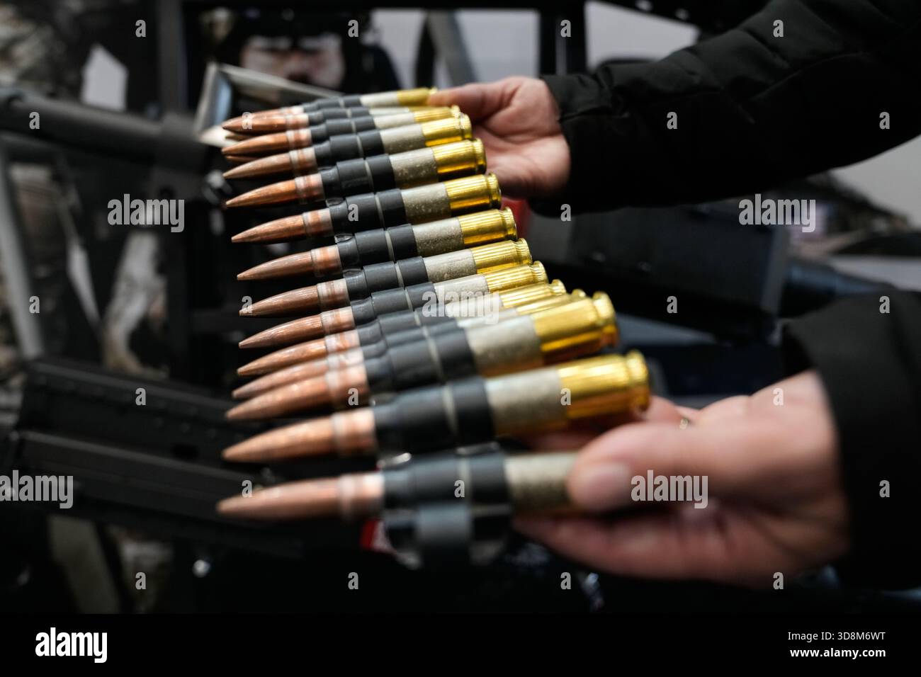 A man holds out bullets during the Expodefensa fair in Bogota, Colombia ...