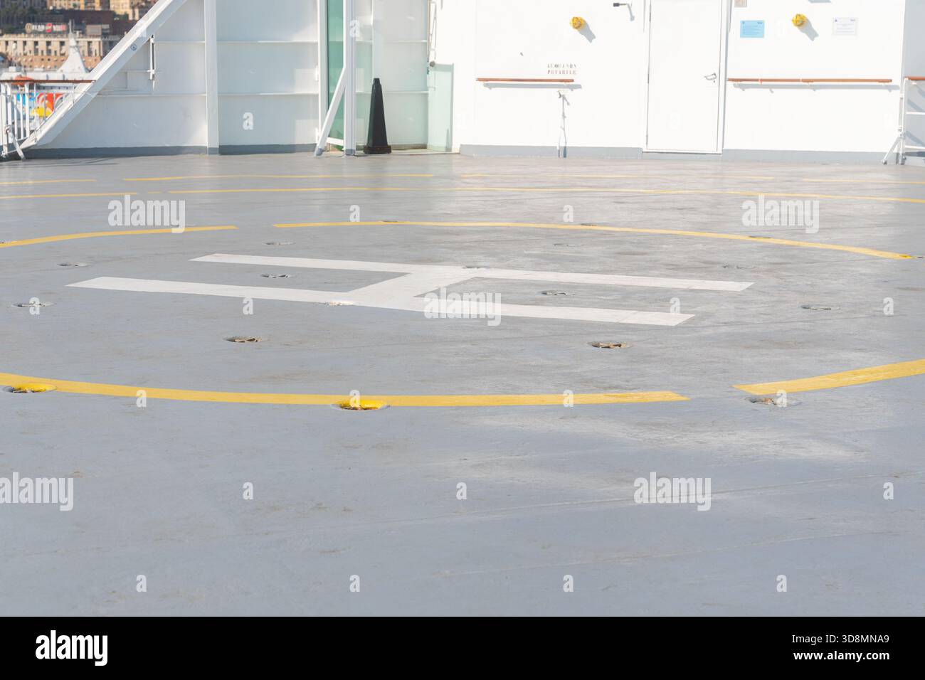 Empty helipad marked with a large H on the deck of a ship. Clean lines ...