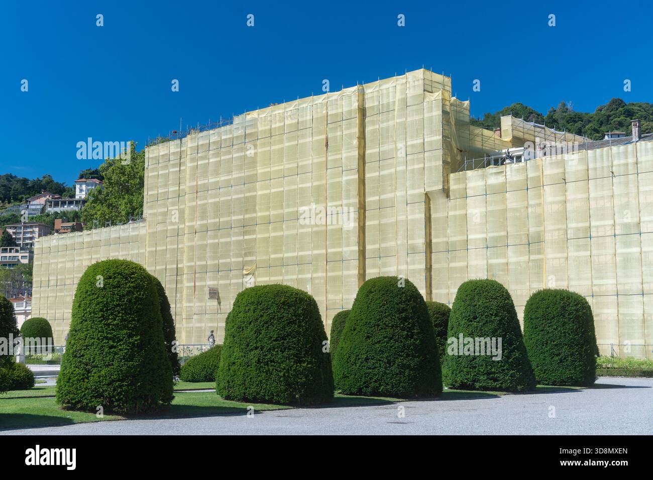 A modern building is fully wrapped in protective film during ...