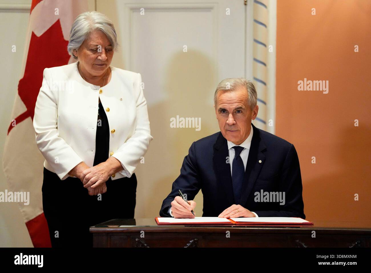 Canada's Prime Minister Mark Carney participates in a signing as Gov ...