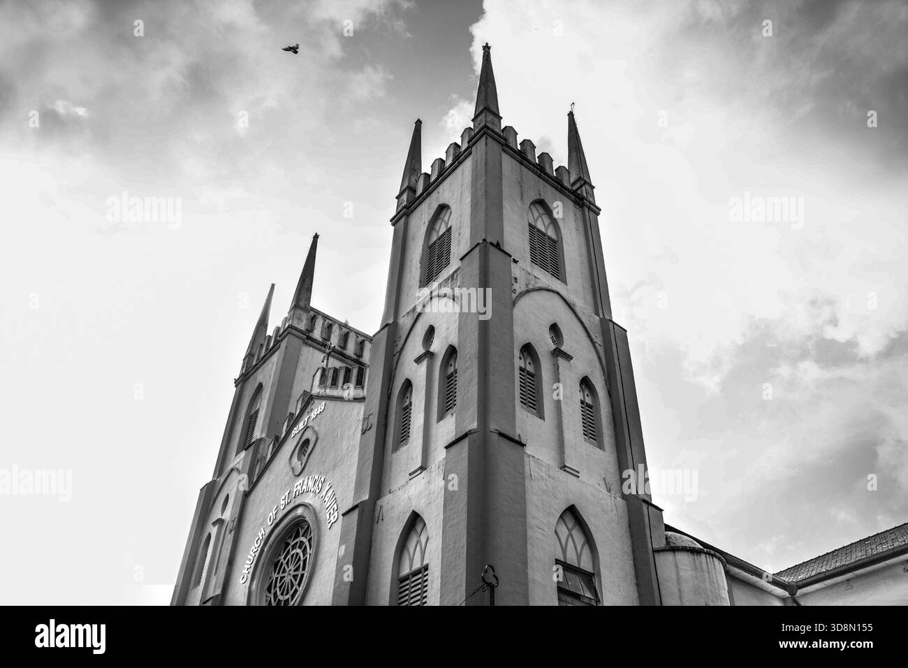 Gothic St. Francis Xavier Church facade with twin towers in black-and ...