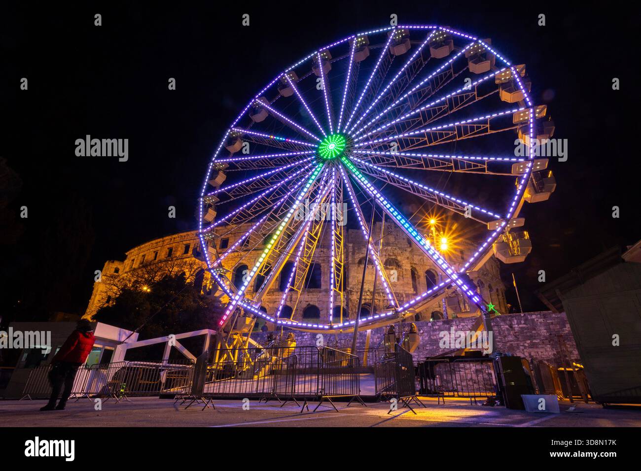 Ferris wheel is seen near the Roman amphitheater in Pula, Croatia, on ...