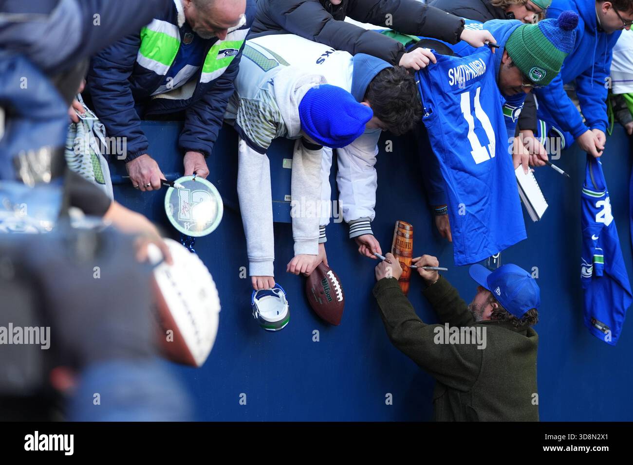 Seattle Seahawks general manager John Schneider signs autographs for ...
