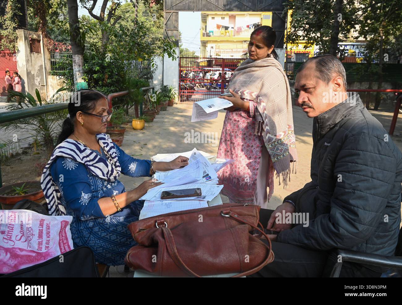 NOIDA, INDIA - DECEMBER 1: BLOs helping voters fill thier enumeration ...