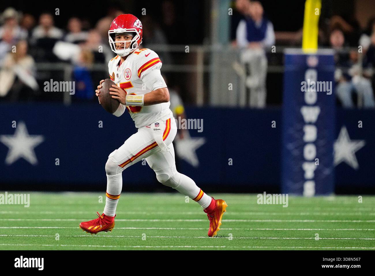 Kansas City Chiefs quarterback Patrick Mahomes rolls out of the pocket ...