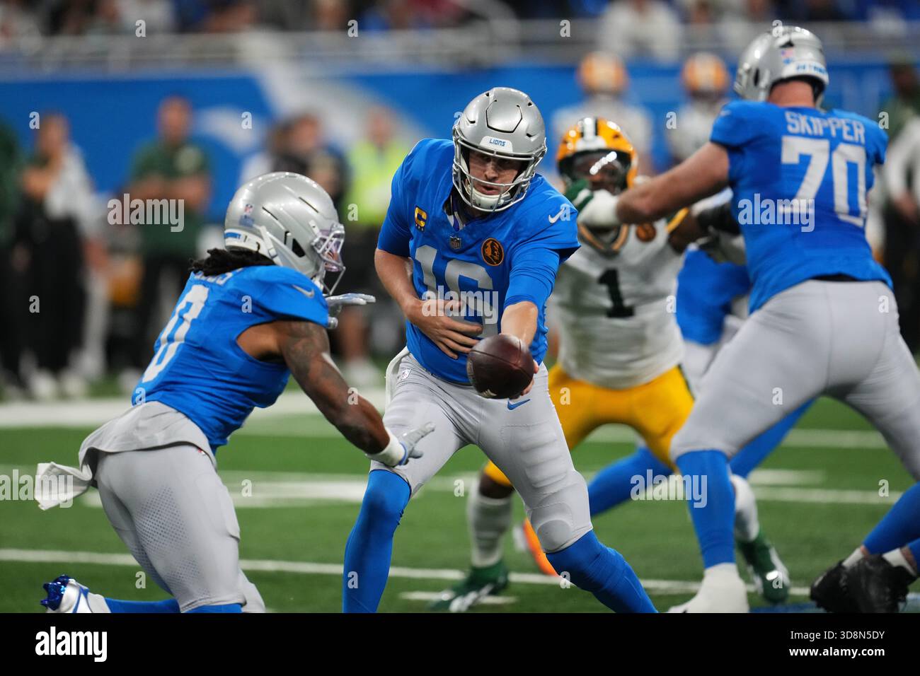 Detroit Lions quarterback Jared Goff (16) hands off to running back ...