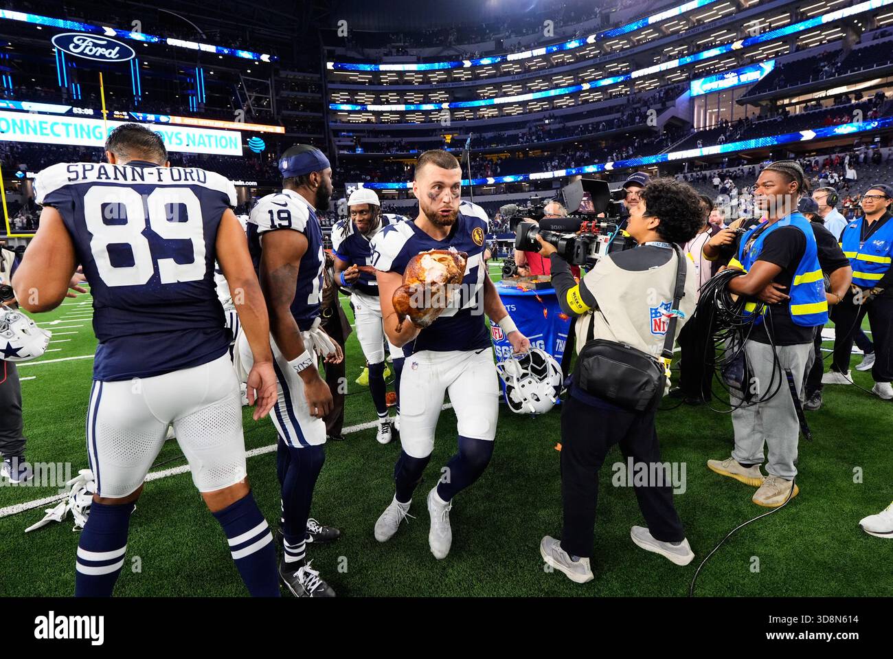 Dallas Cowboys tight end Jake Ferguson sprints away with a turkey after ...