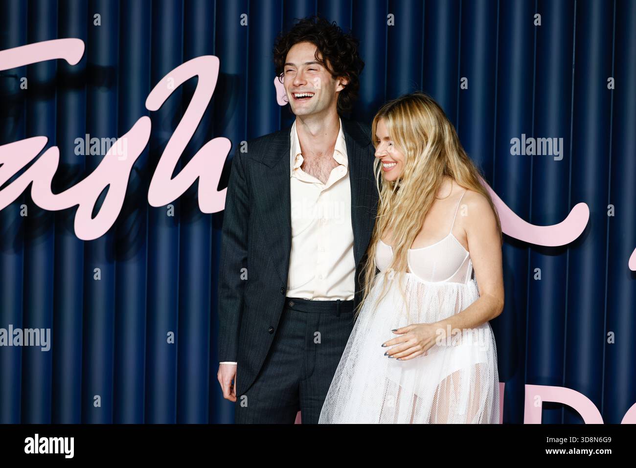 Oli Green, from left, and Sienna Miller pose for photographers upon ...