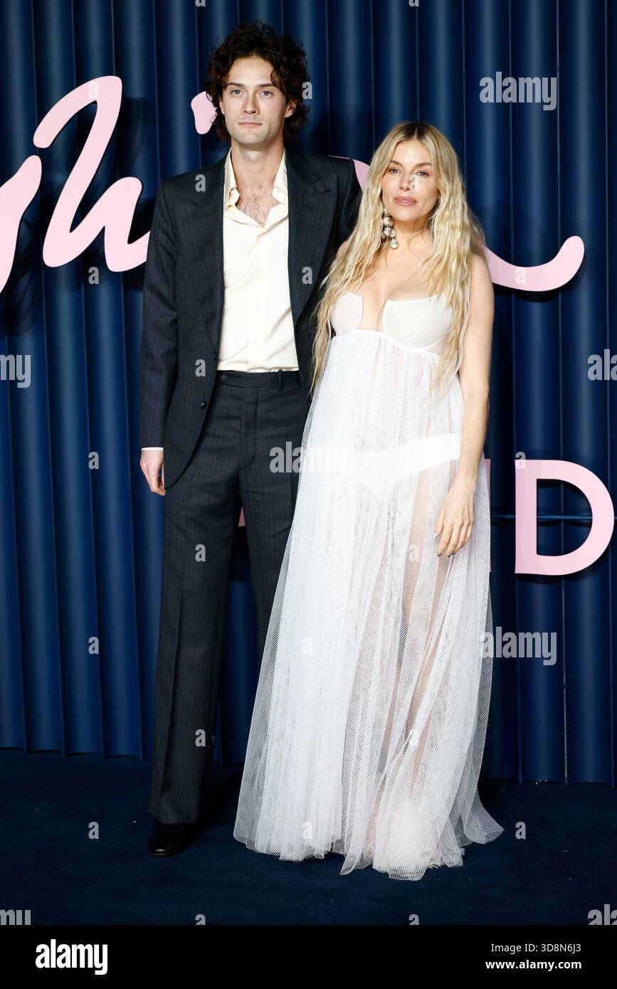 Oli Green, from left, and Sienna Miller pose for photographers upon ...