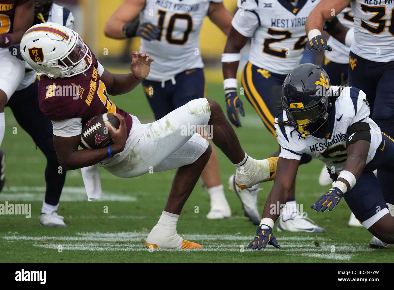 Arizona State quarterback Jeff Sims (2) gets tackled by West Virginia ...