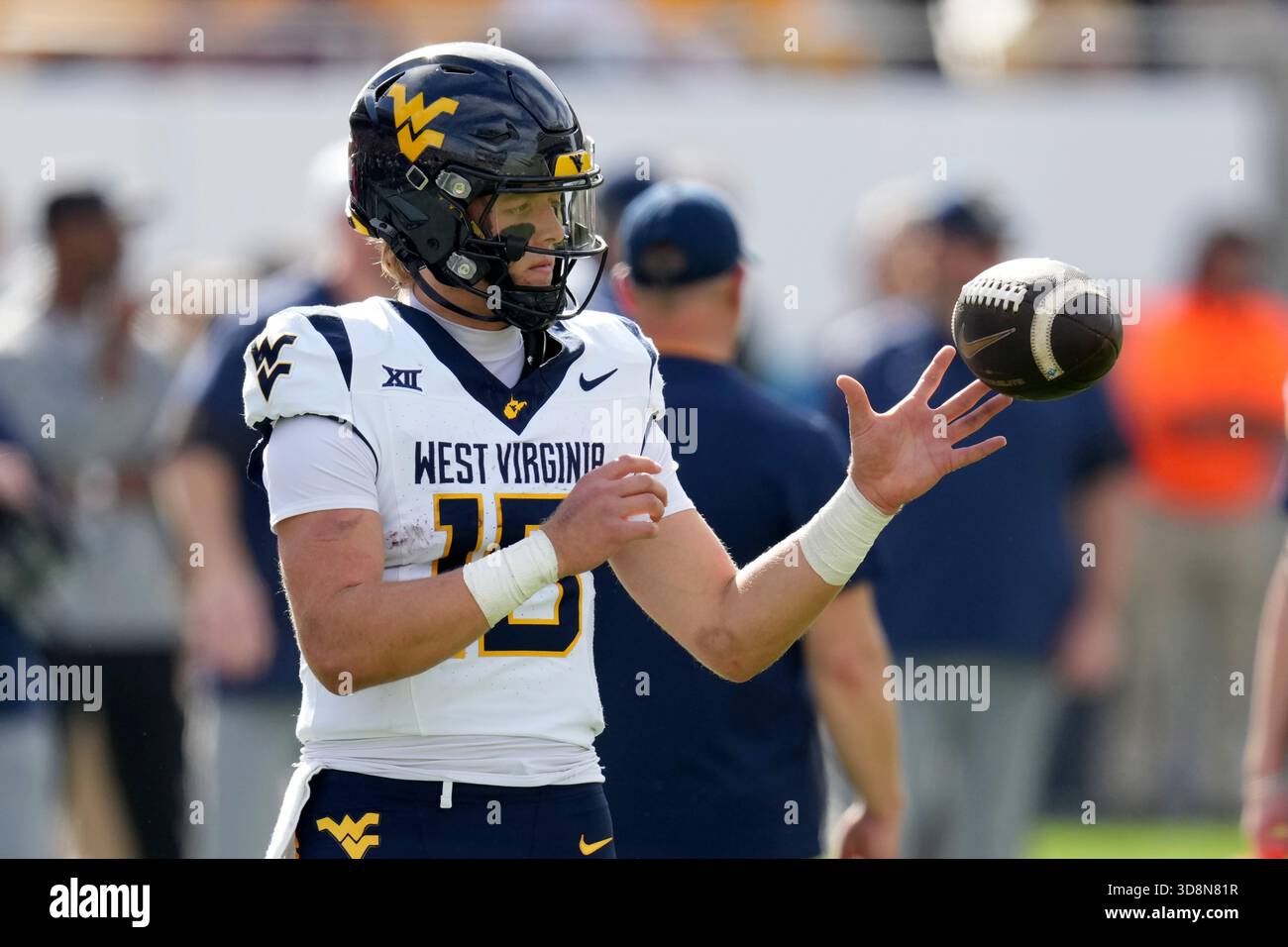 West Virginia quarterback Scotty Fox Jr. warms up on the sideline ...