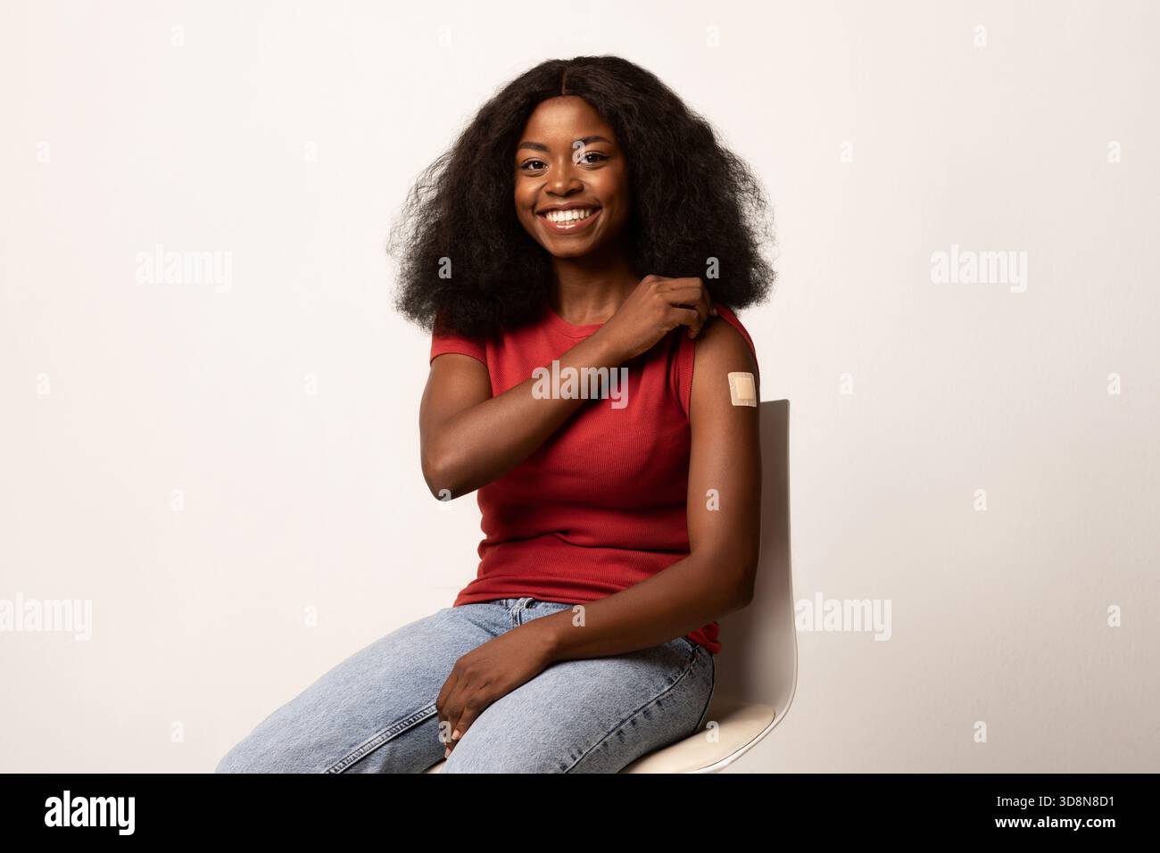 Joyful Black Woman Shows Bandaged Arm Post-Covid Vaccine in a ...