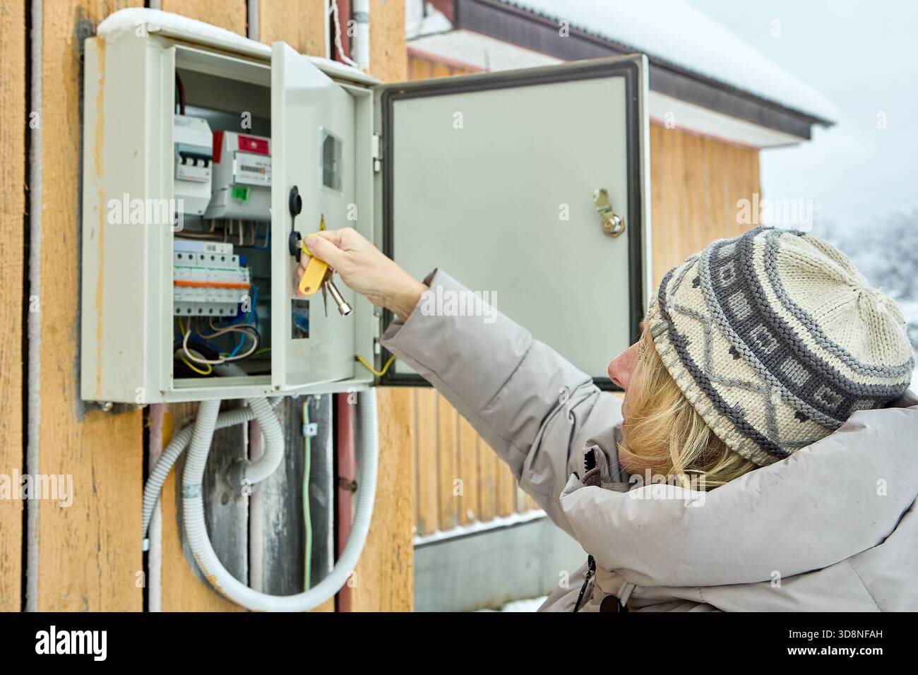 Examining open electrical cabinet homeowner observes breakers with ...