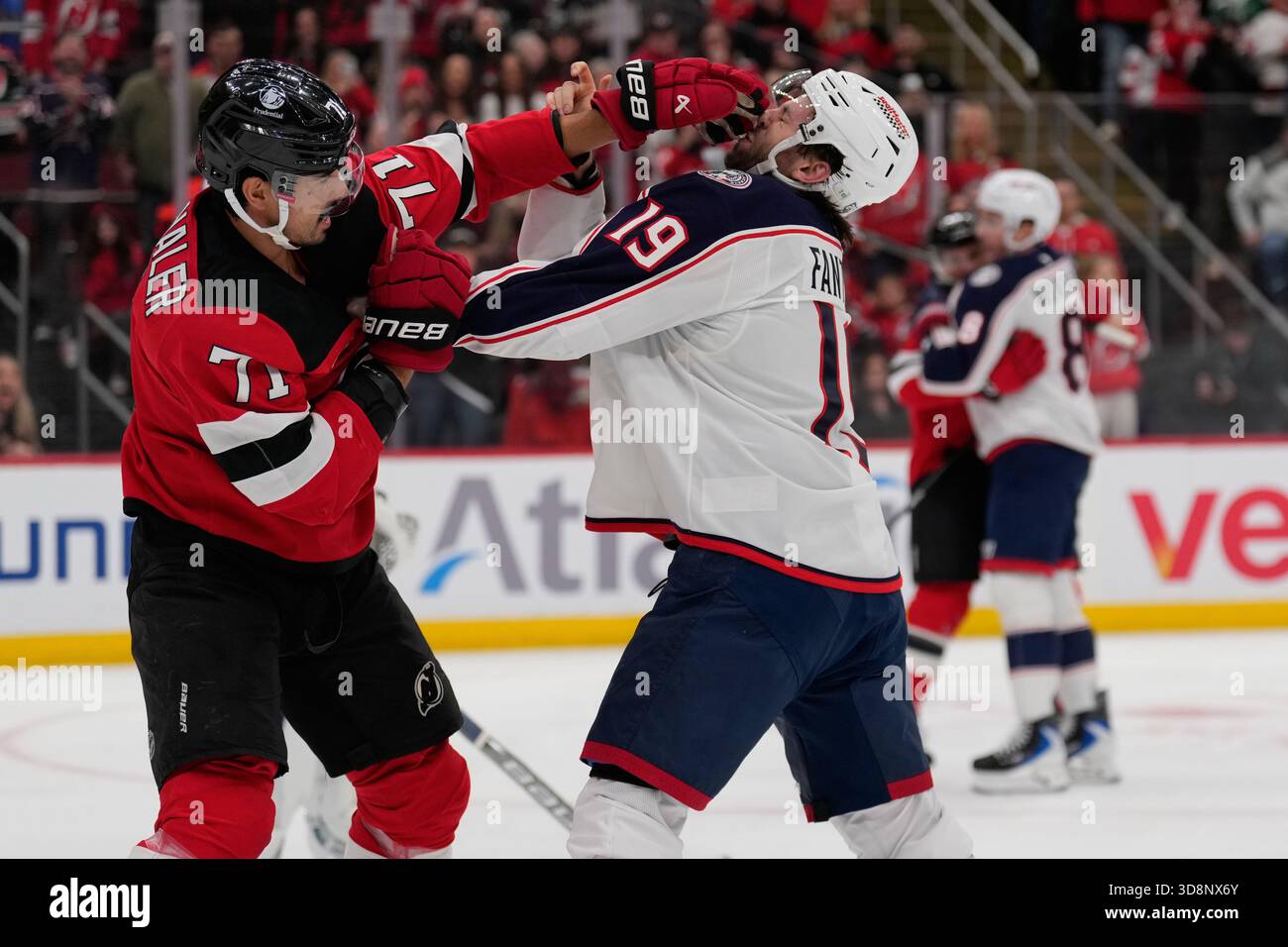 New Jersey Devils' Jonas Siegenthaler, left, and Columbus Blue Jackets ...