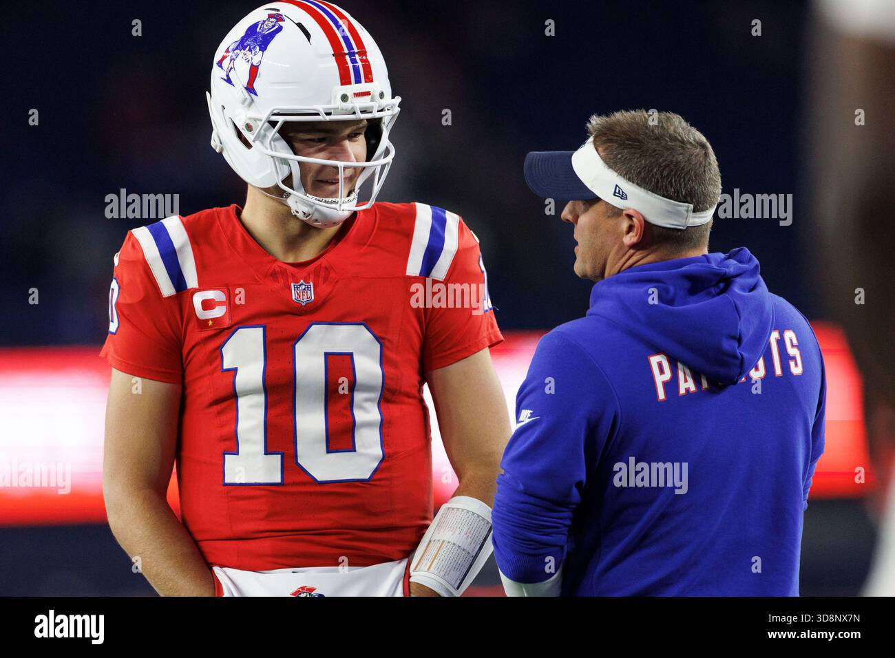 New England Patriots quarterback Drake Maye (L) talks with New England ...