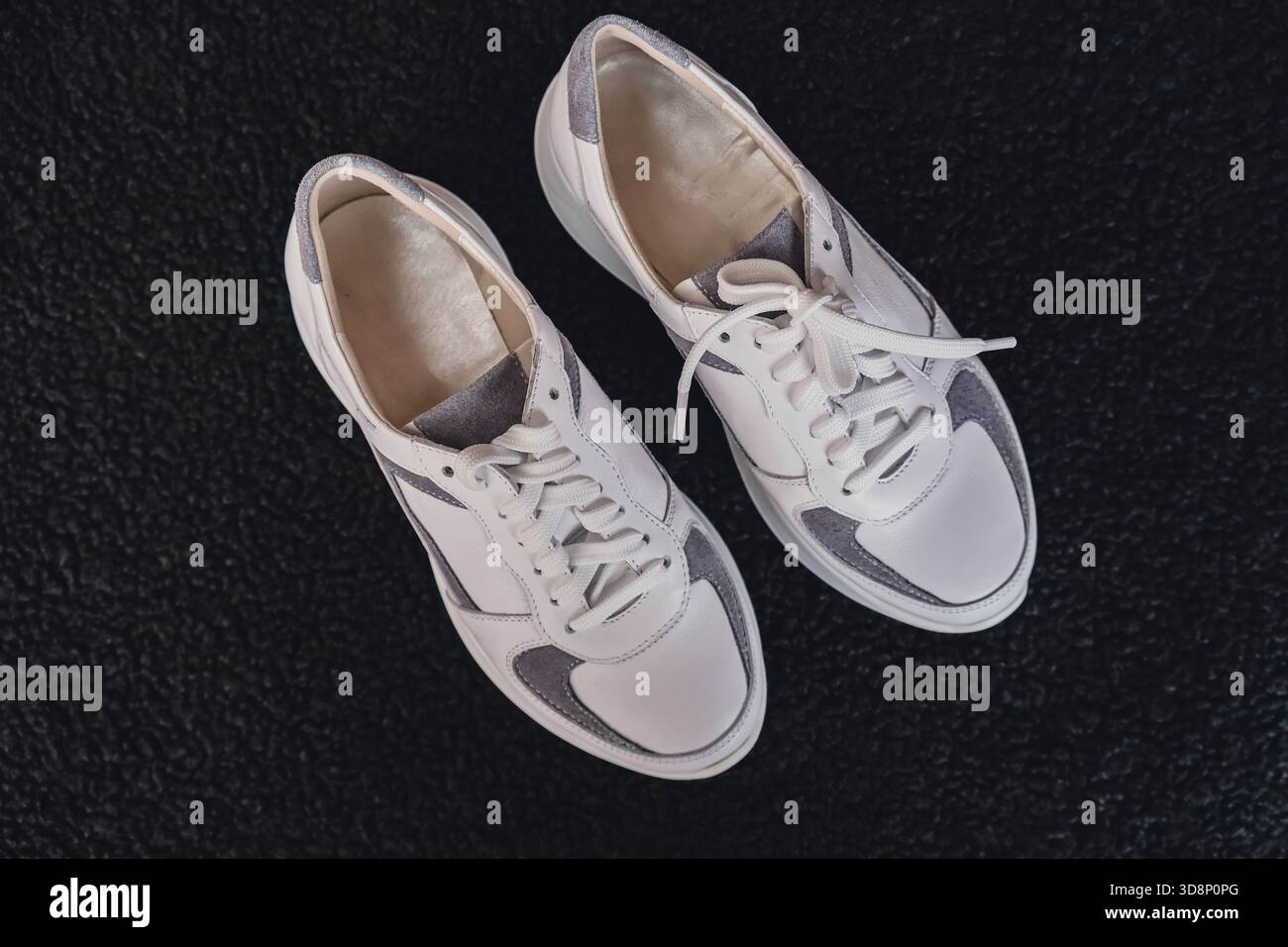 Fresh beige leather sneakers without brand marks displayed. For design ...