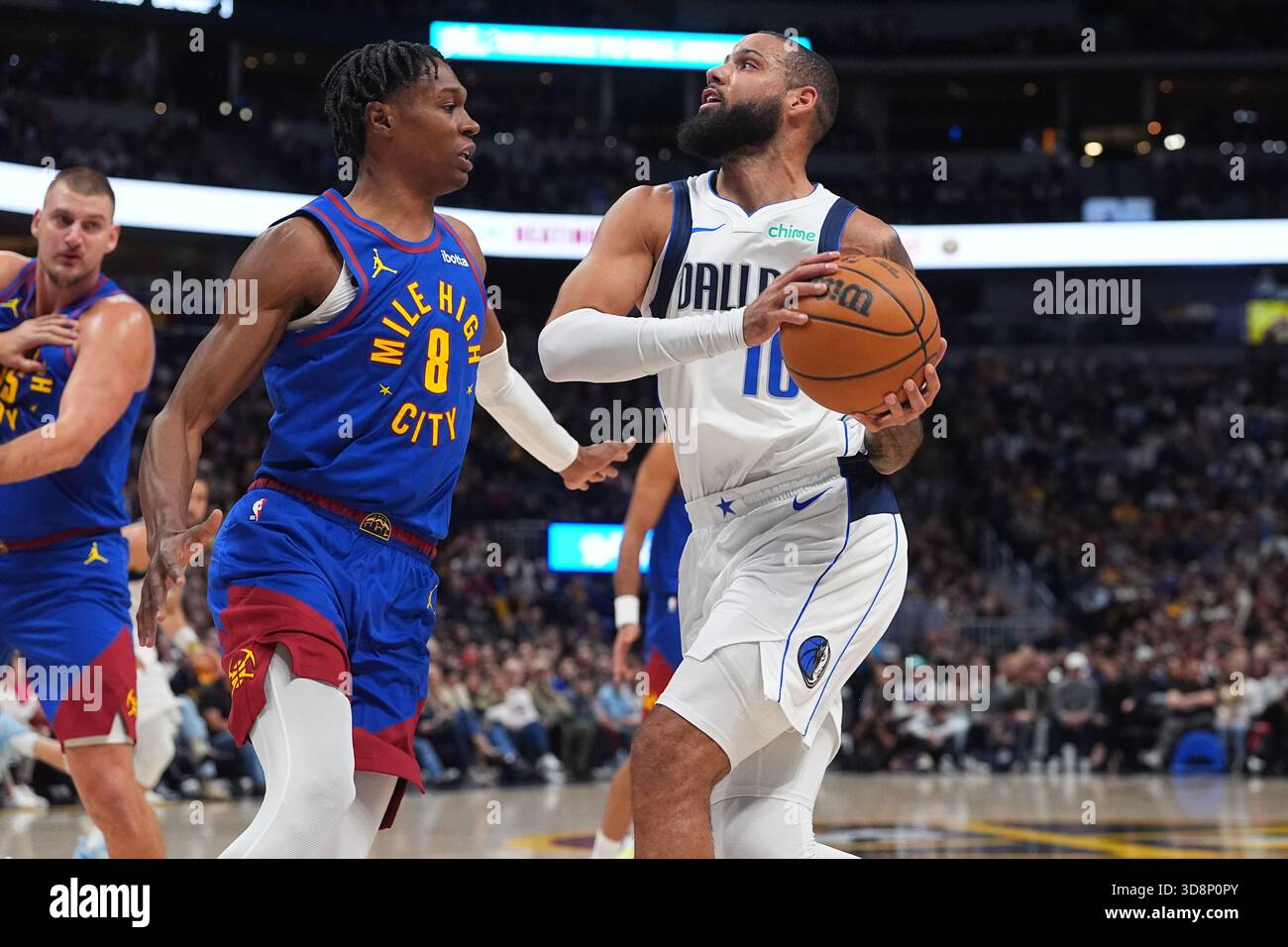 Dallas Mavericks forward Caleb Martin, right, drives to the basket as ...