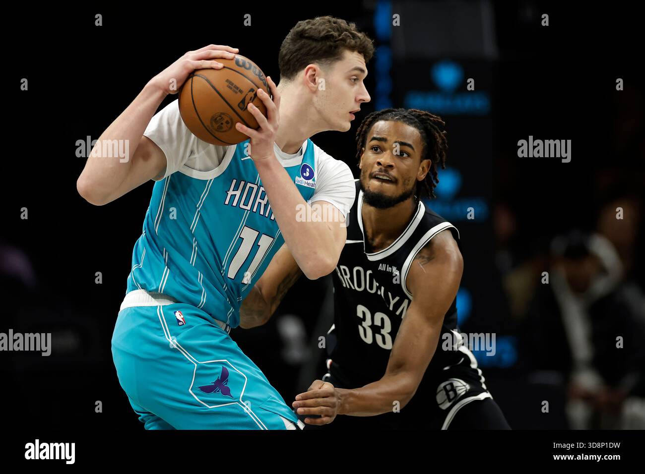 Charlotte Hornets center Ryan Kalkbrenner (11) looks to pass around ...