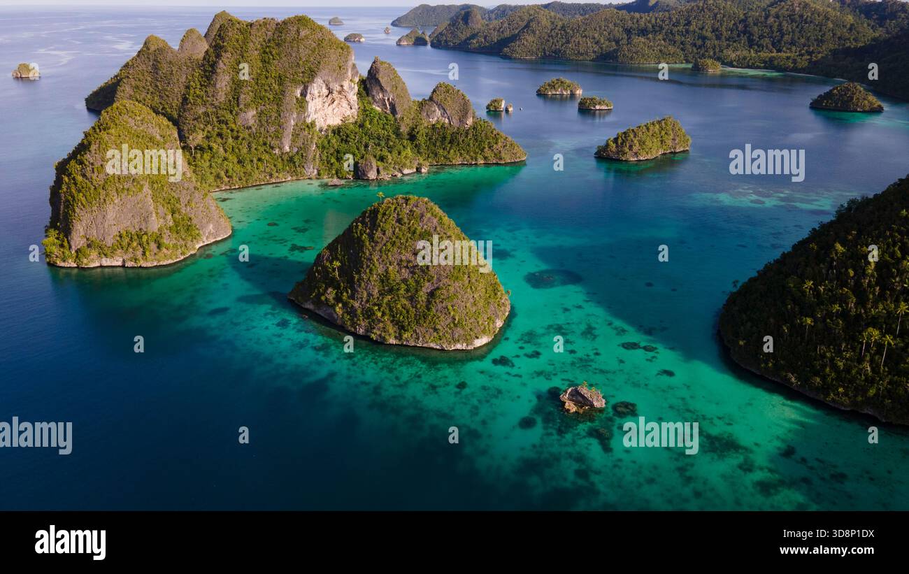 Aerial image of the green karst islands and protected reefs of Wayag ...