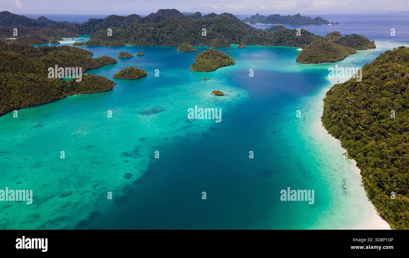 Aerial image of the green karst islands and protected reefs of Wayag ...