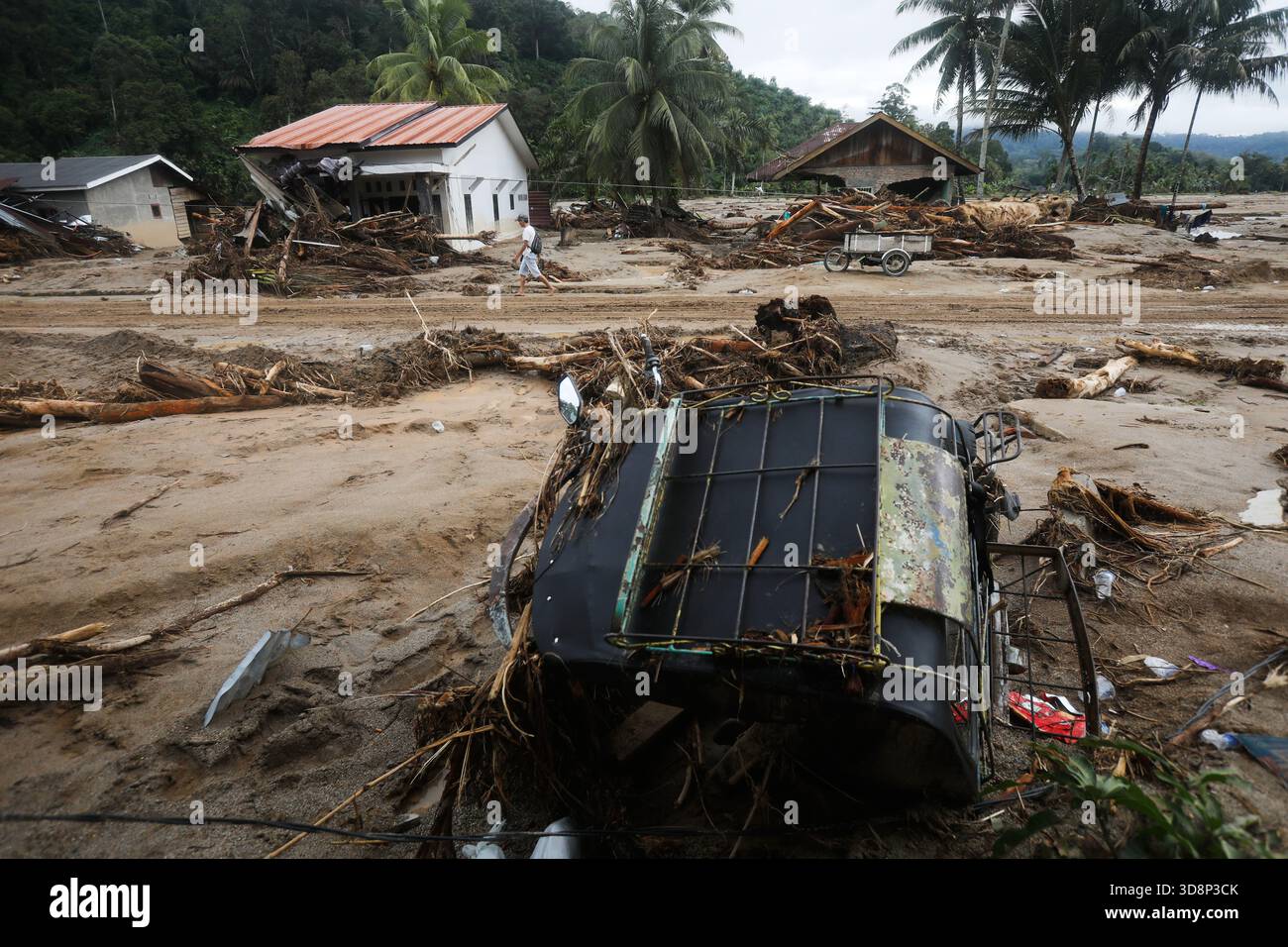 Debris litters a village affected by a flash flood in Batang Toru, North Sumatra, Indonesia ...