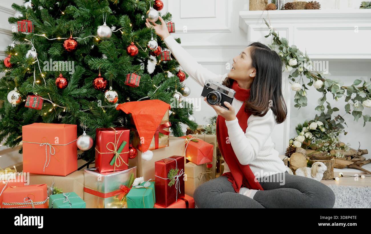 Asian woman using camera take photo christmas tree xmas present gift ...