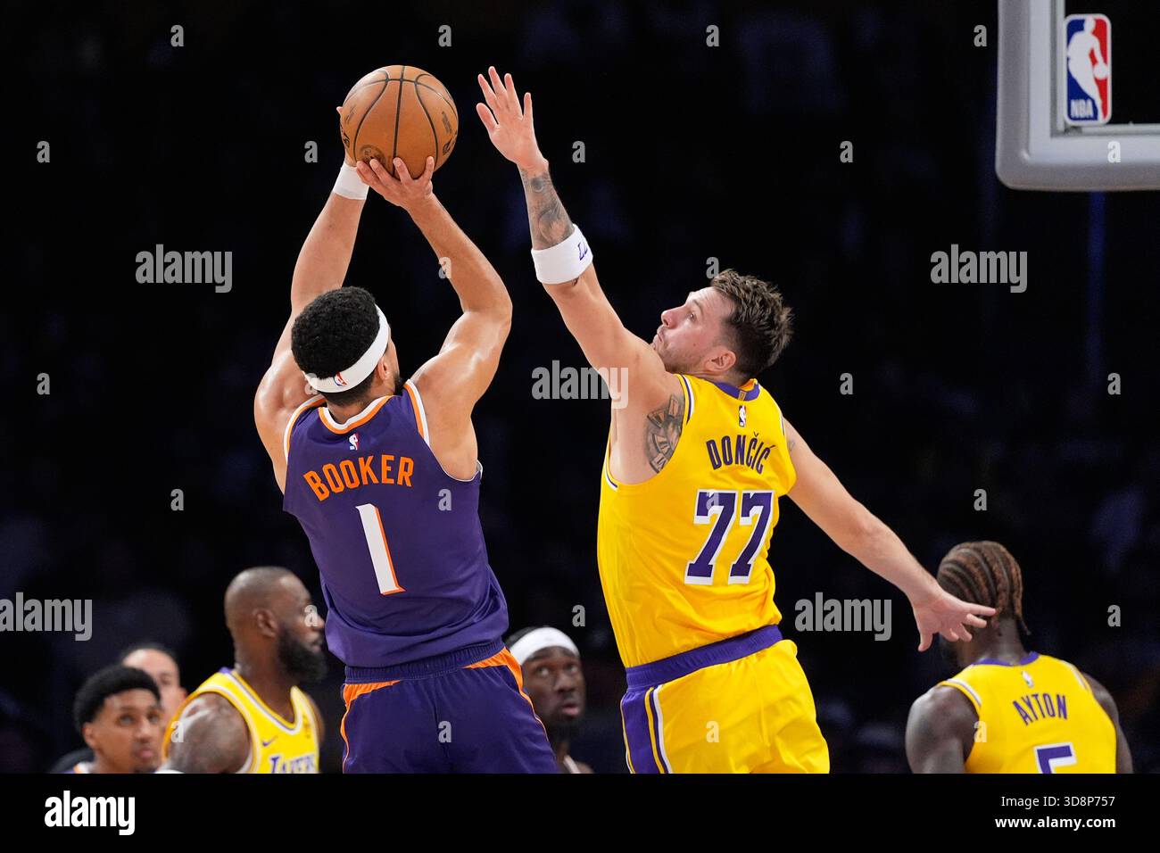 Phoenix Suns guard Devin Booker, left, shoots as Los Angeles Lakers ...