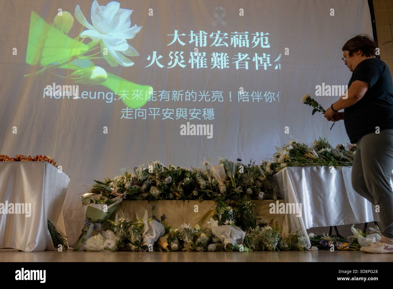 A mourner at a memorial in a funeral home for the victims who lost ...
