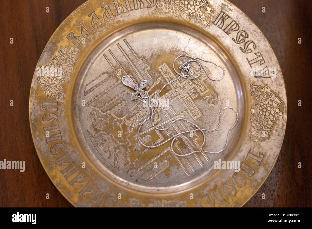 Overhead close-up of small silver Orthodox pectoral cross for baby ...